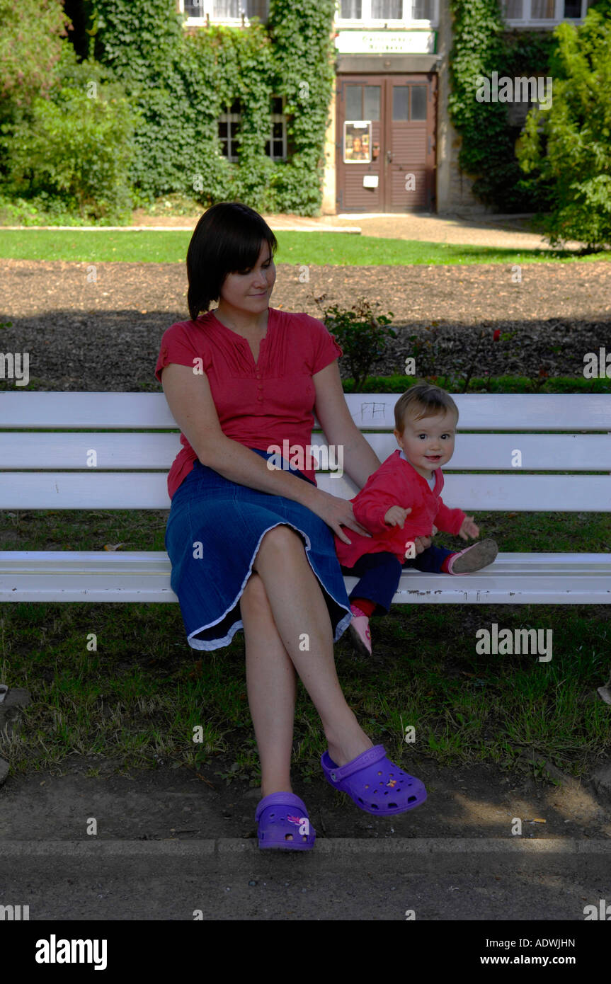 single mother on bench with baby daughter in summertime Stock Photo - Alamy