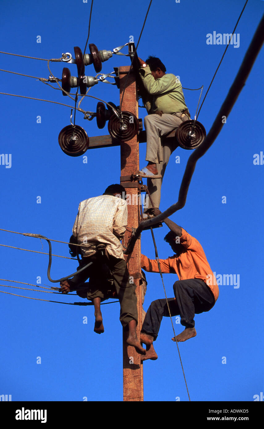 Three men repairing power lines in Bhuj Gujarat India after earthquake ...