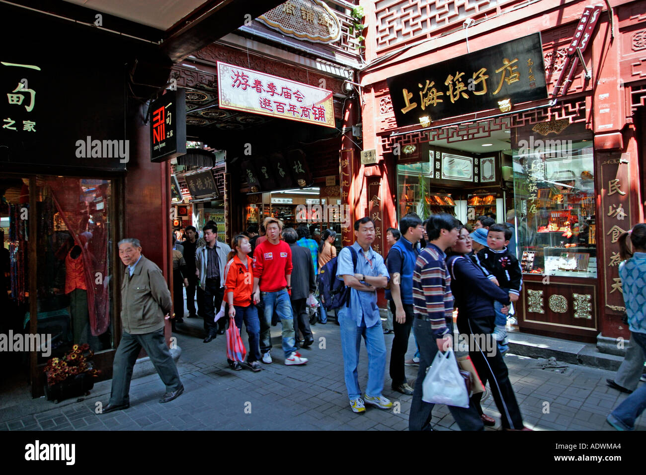Shoppers flow through the narrow passageways at the Old City inShanghai ...