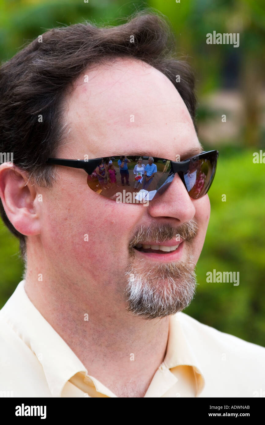 A preacher at a wedding rehearsal with his bible the bride and her ...