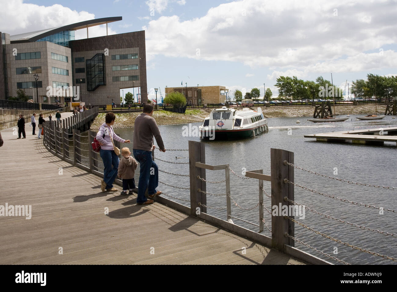 Wales Cardiff Bay family watching arriving waterbus Stock Photo - Alamy
