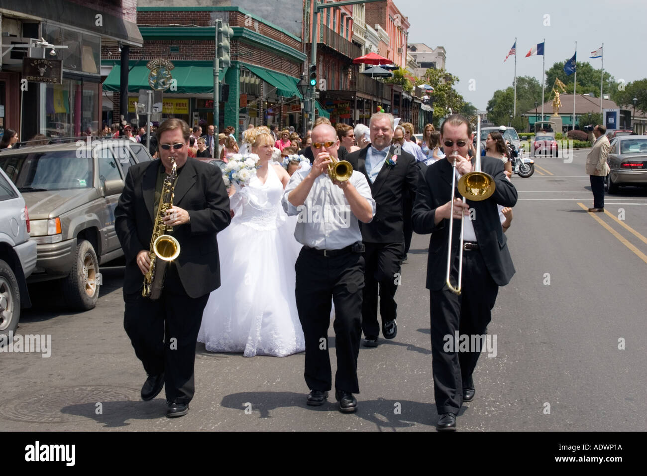 Musicians lead a wedding parade down a major street in New Orleans ...