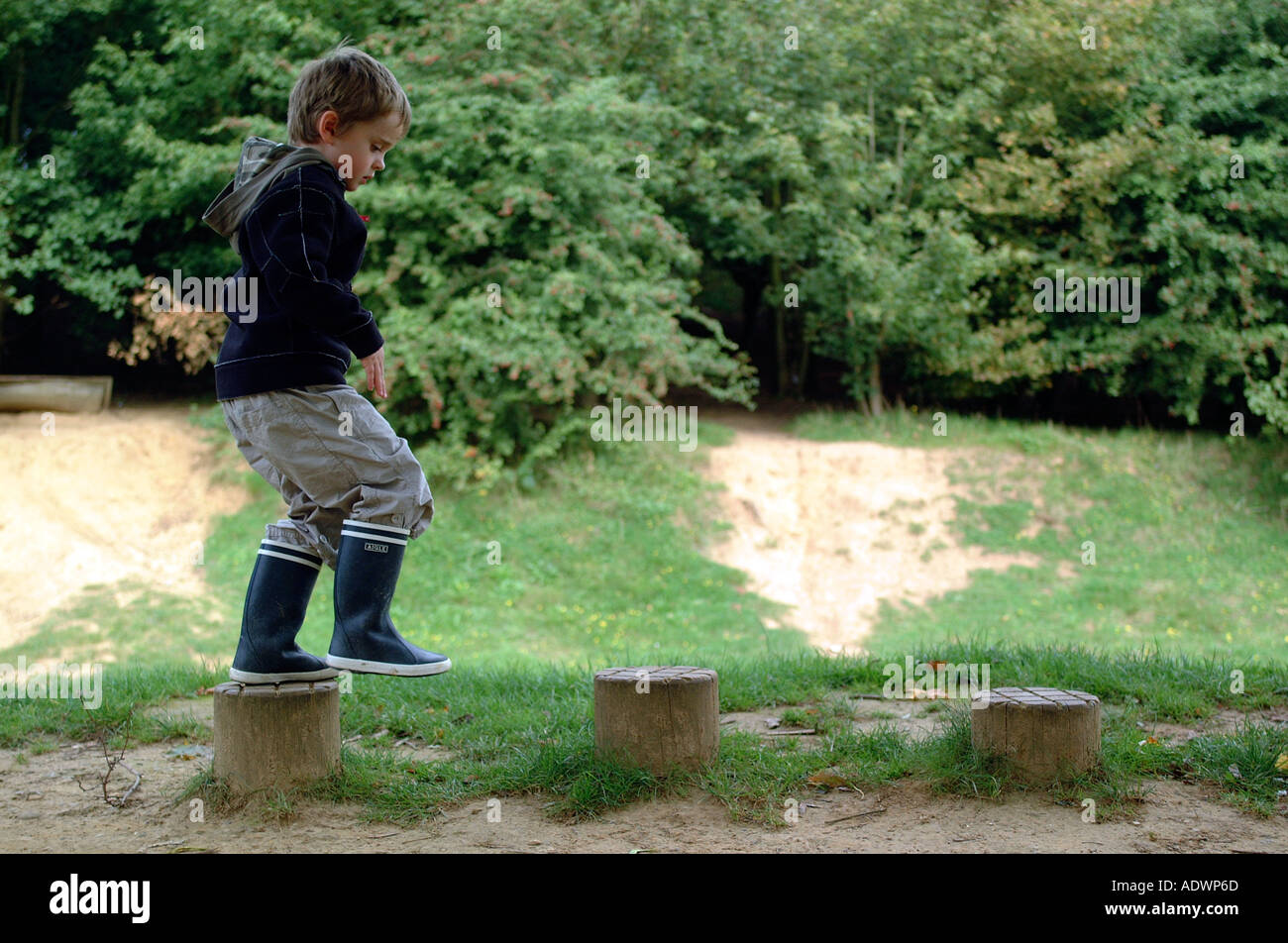 boy balancing on wooden blocks Stock Photo - Alamy