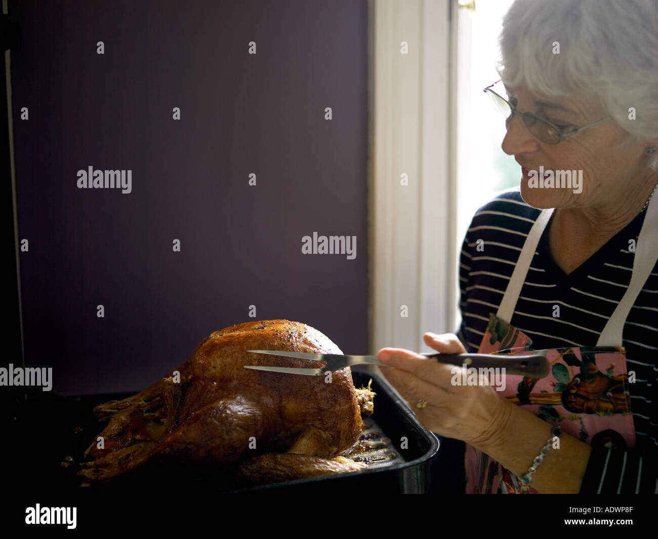 Woman taking roast chicken hi-res stock photography and images - Alamy