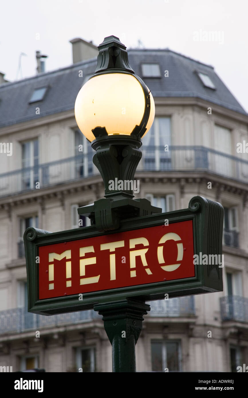 Metro sign in front of typical Parisian apartment block architecture ...