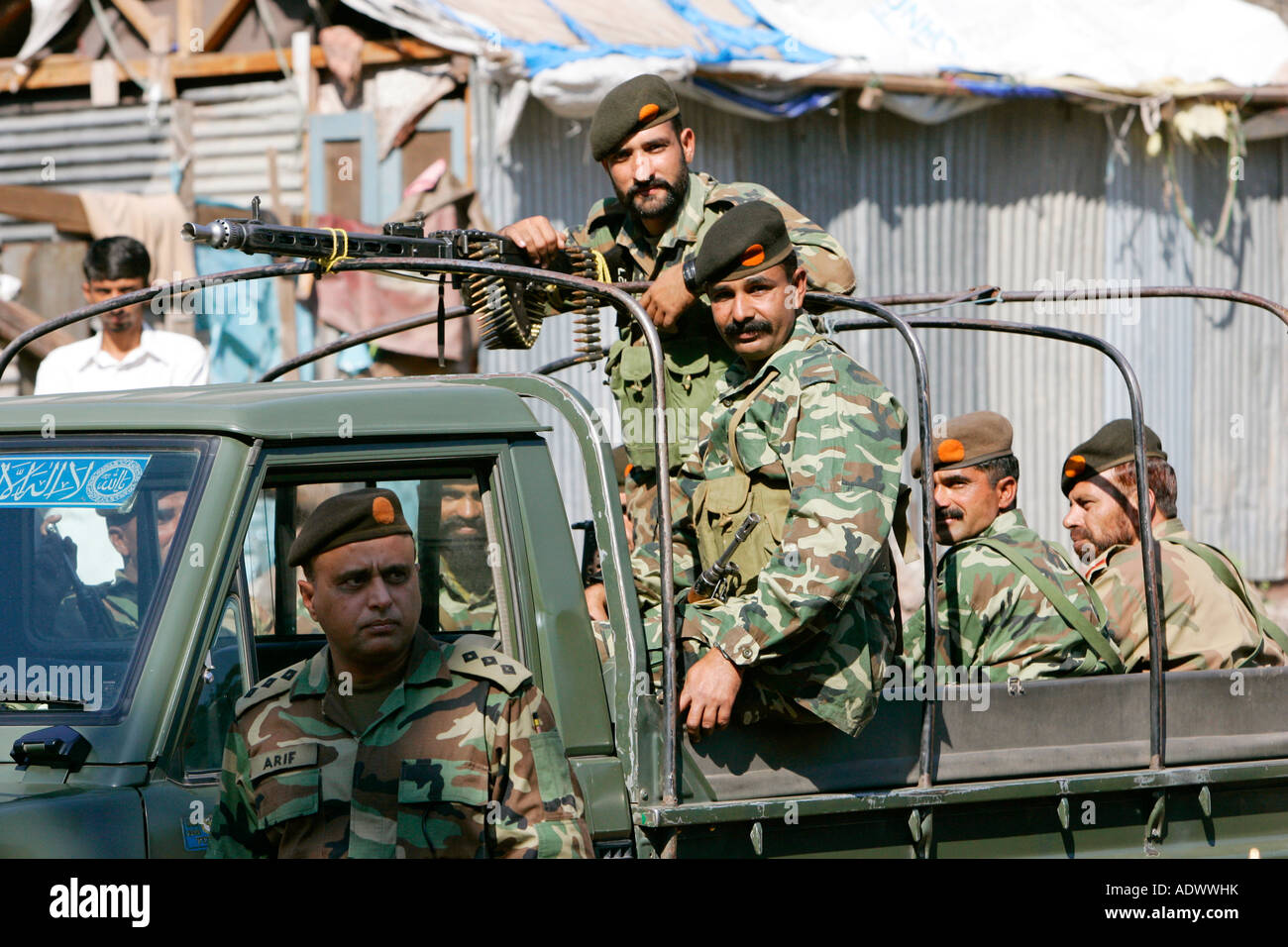 Armed Pakistani soldiers in open top vehicle with machine gun in ...