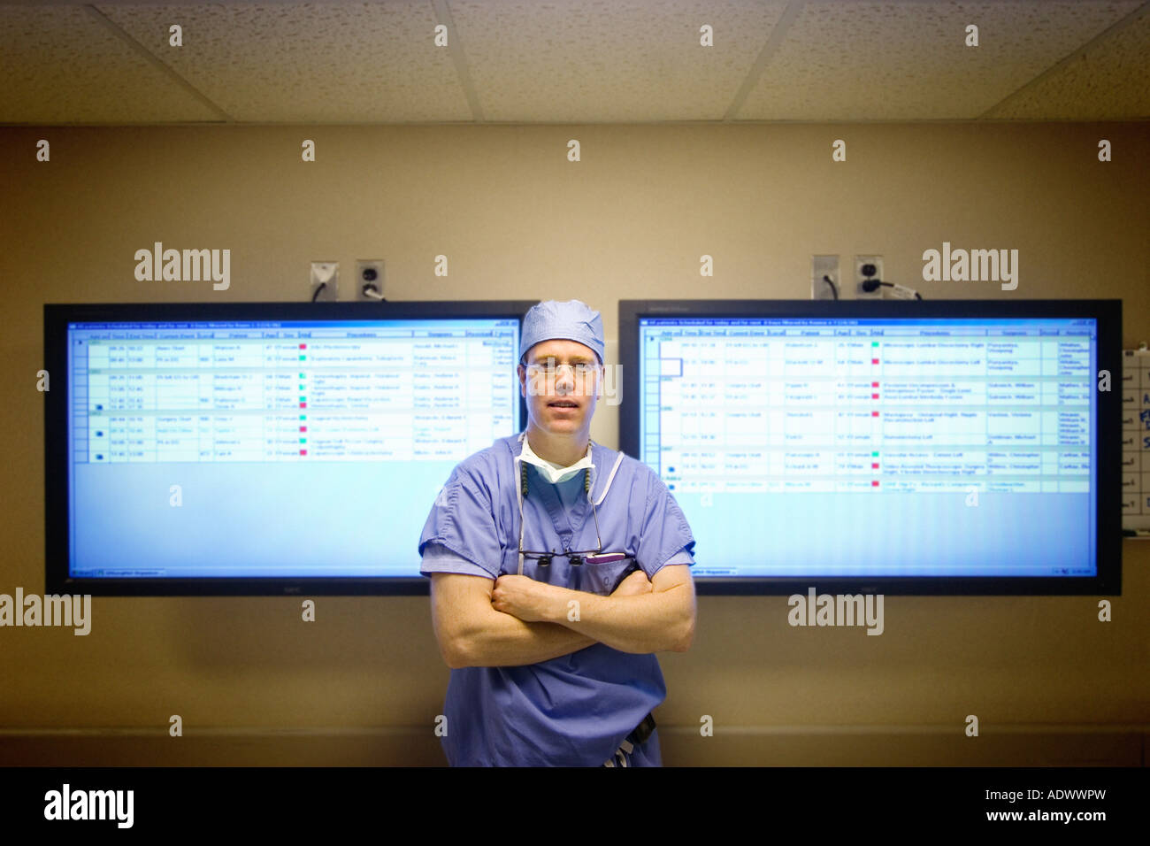portrait of doctor standing before two 2 information or scheduling ...