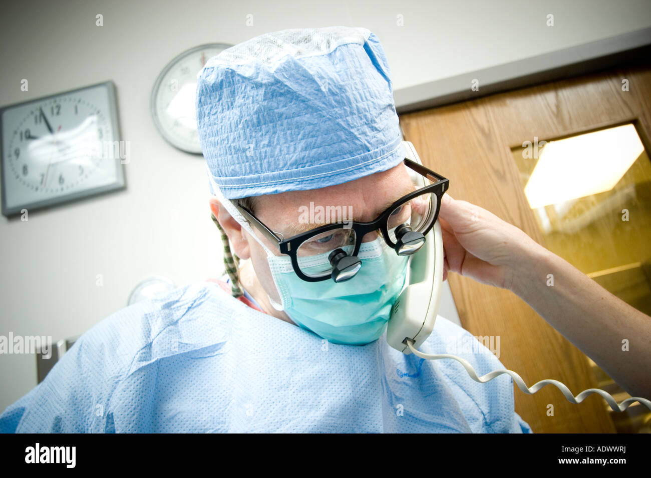 surgeon talking on telephone in operating room Stock Photo - Alamy