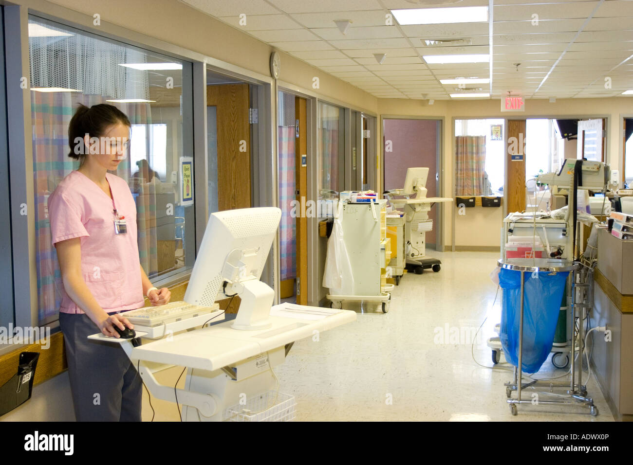 A nurse enters information into a mobile computer work station outside ...