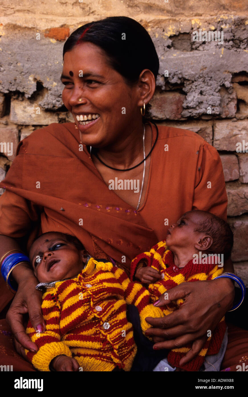 Woman holding twins in the slums of Kathmandu, Nepal Stock Photo - Alamy