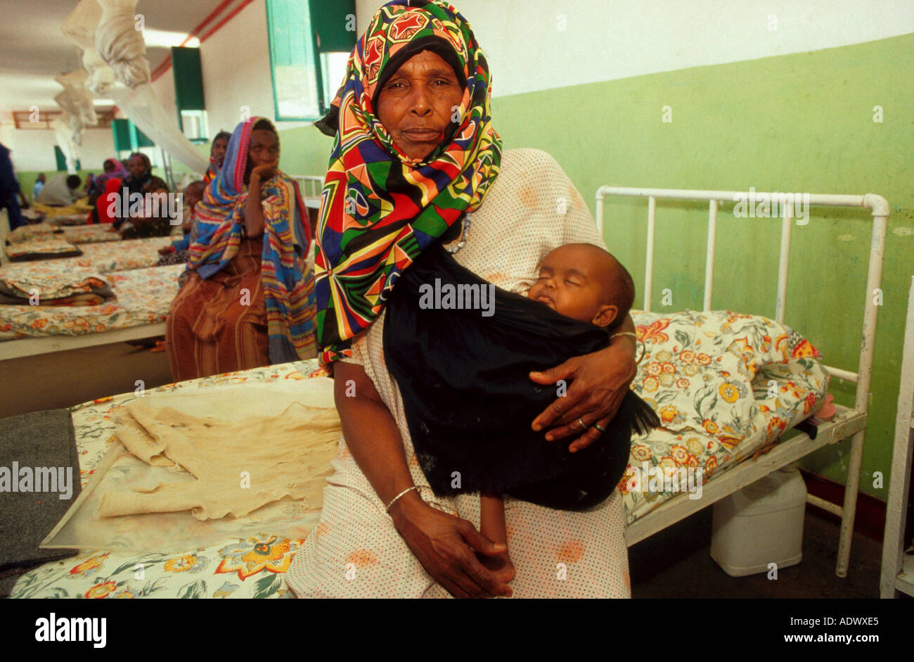 Grandmother holds her grandchild suffering from tuberculosis in Boroma ...