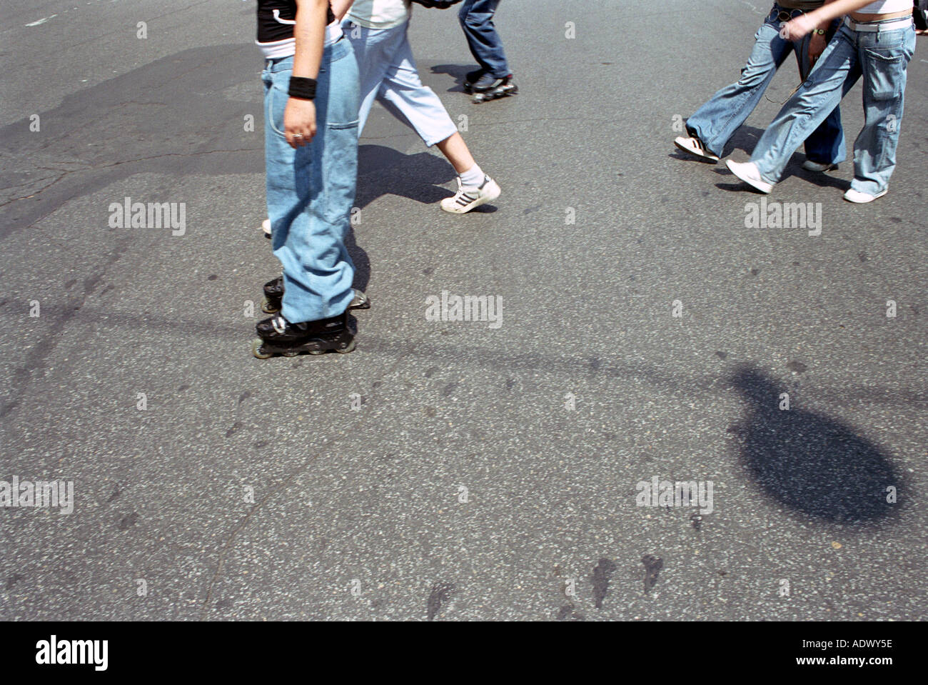detail of teenage rollerblader and crowd in town Stock Photo - Alamy