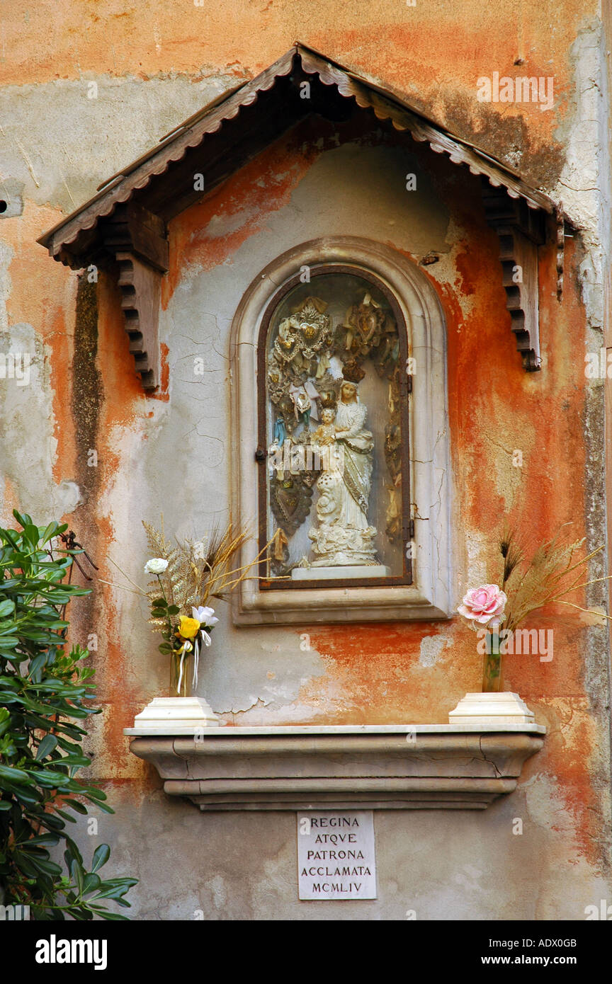 A religious shrine built into the wall of a building in the colourful ...