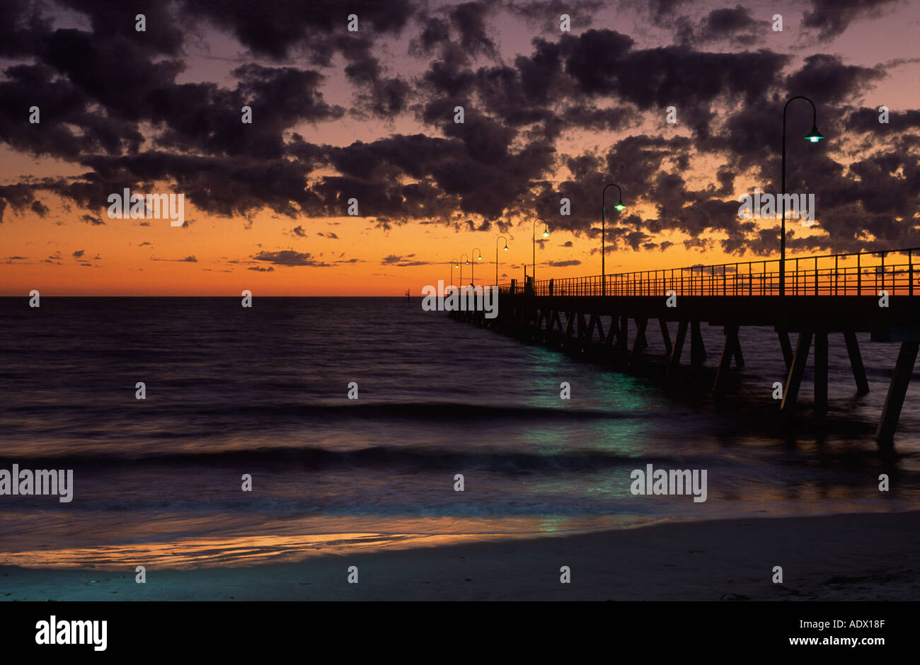 Jetty with lights after sunset Stock Photo - Alamy