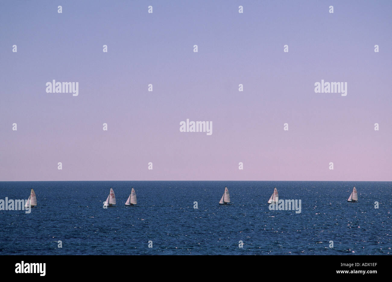 Small sailboats racing at sea Stock Photo - Alamy