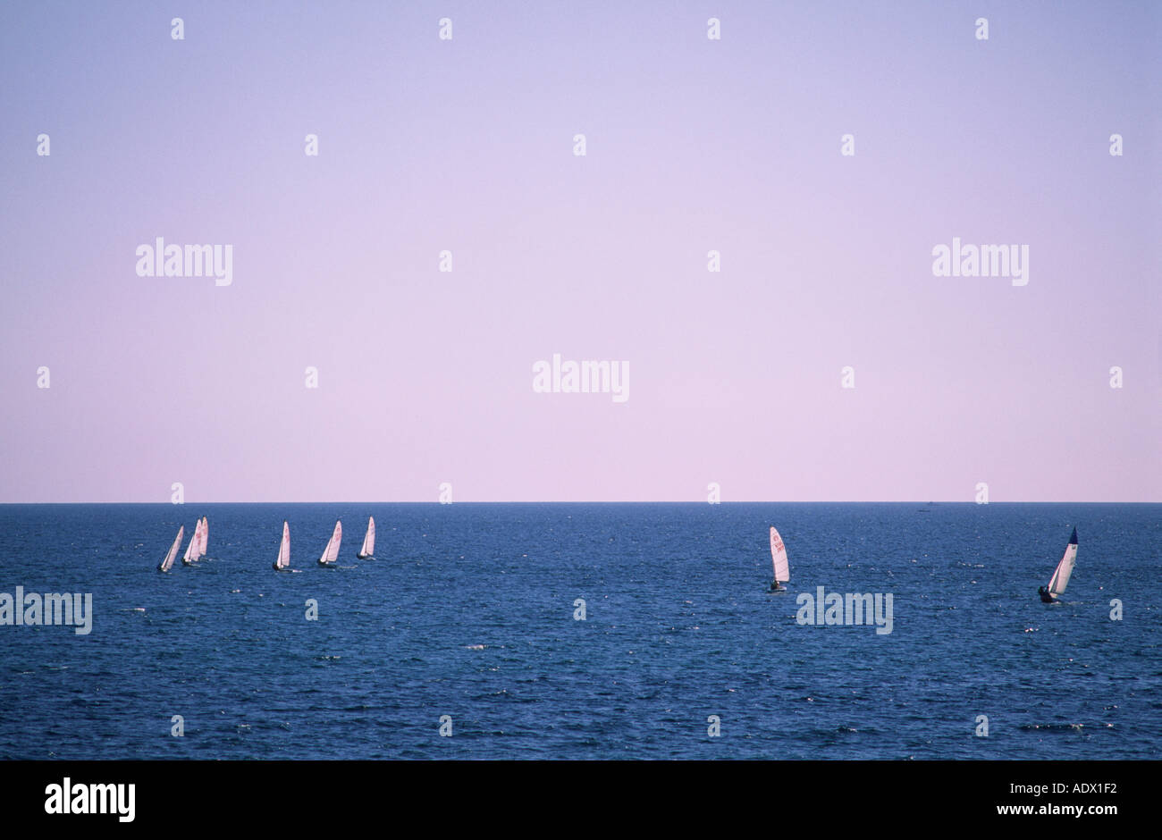 Small sailboats racing at sea Stock Photo - Alamy