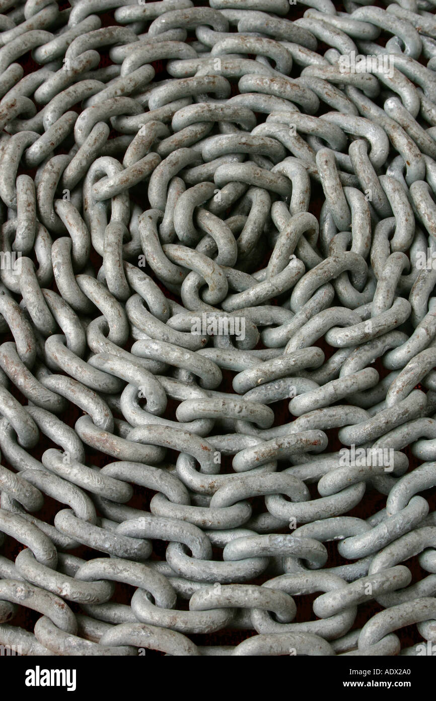 A heavy anchor chain coiled into a spiral Stock Photo - Alamy