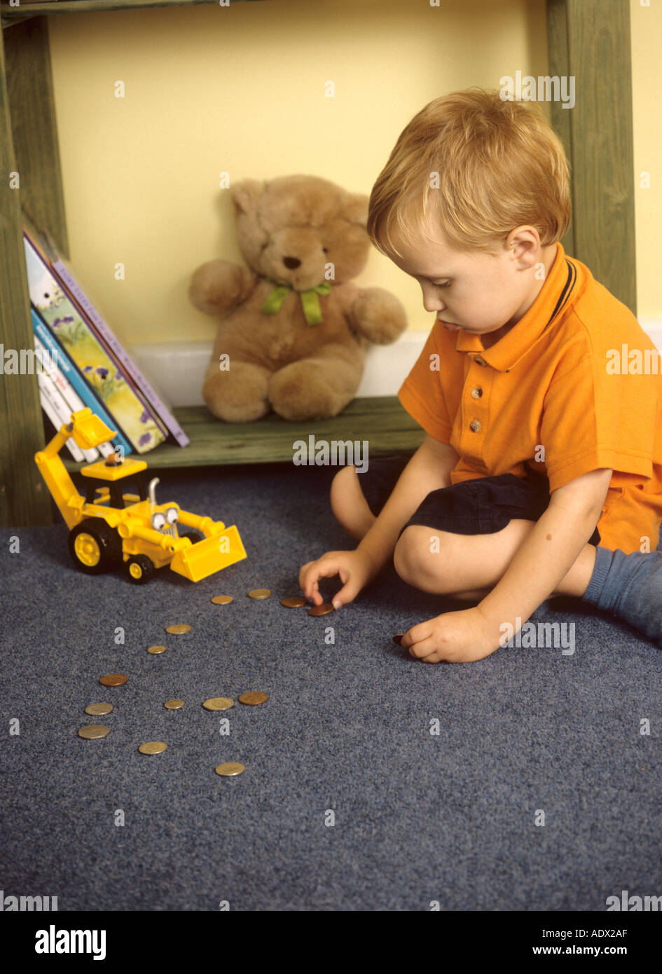 Young boy counting coins Stock Photo - Alamy