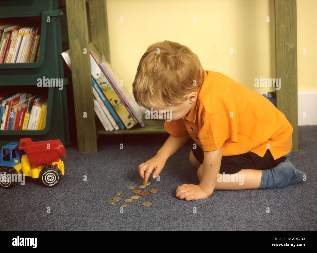 Young boy counting out coins Stock Photo - Alamy