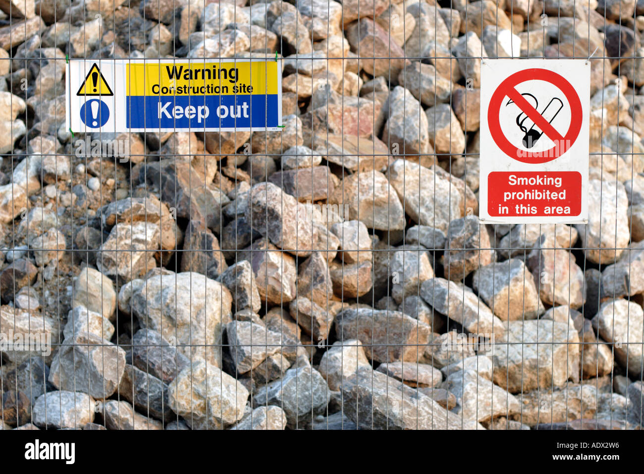 Construction warning signs on rock pile Stock Photo - Alamy