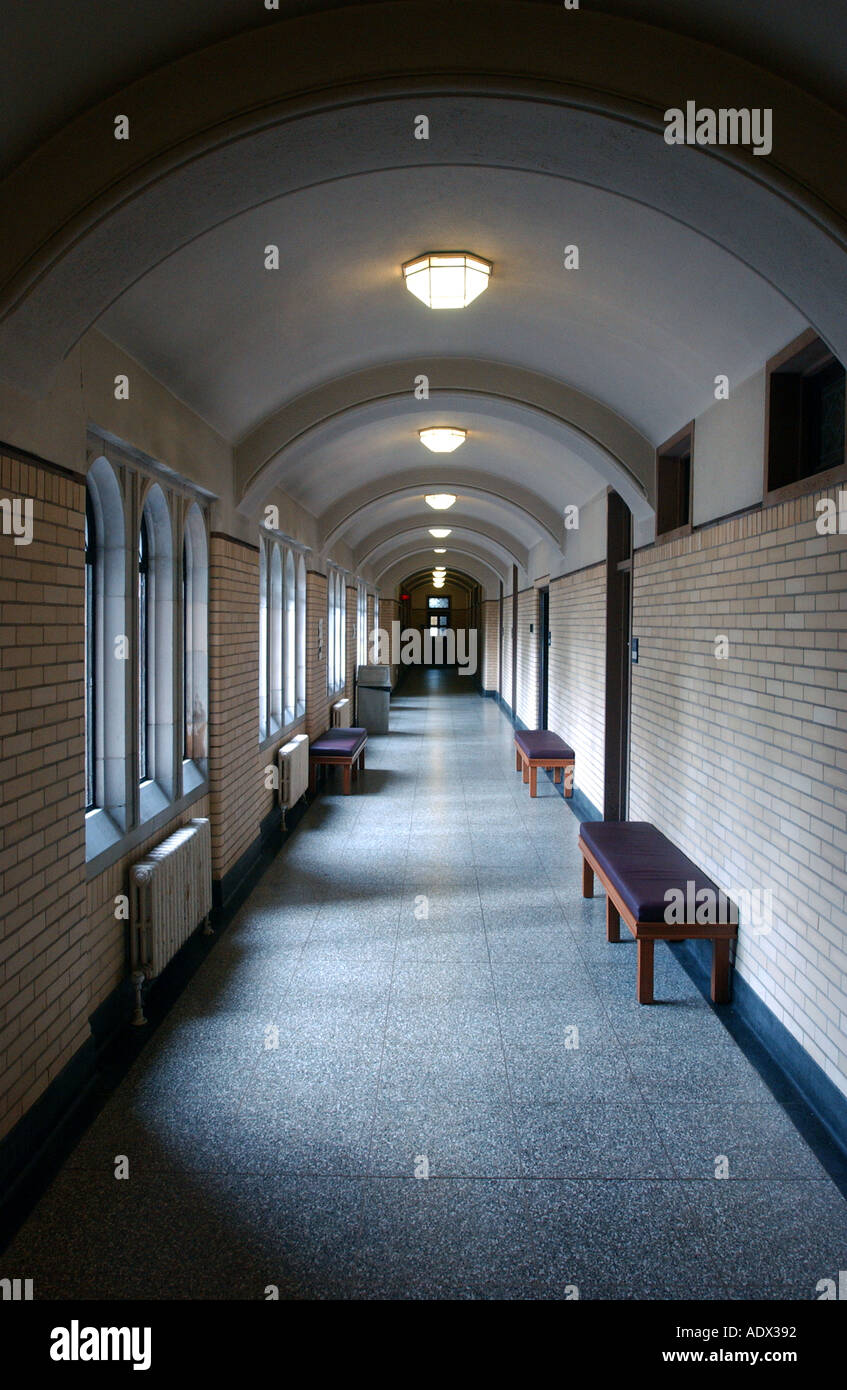 Long Bleak hallway at an hospital institution with benches and windows ...