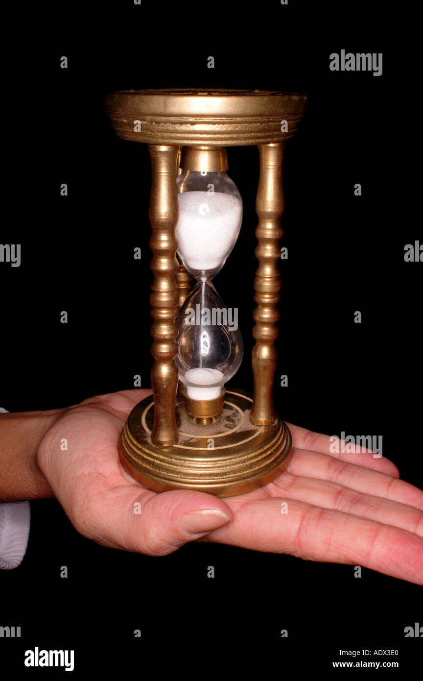 Hourglass with hand hi-res stock photography and images - Alamy