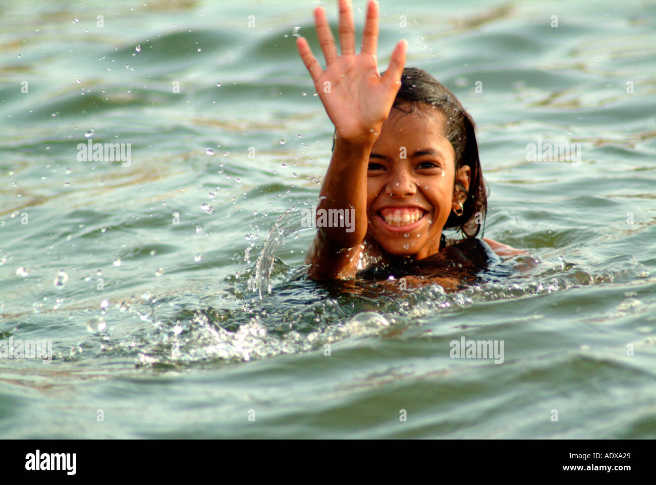 Indian girl waving with smile Stock Photo - Alamy