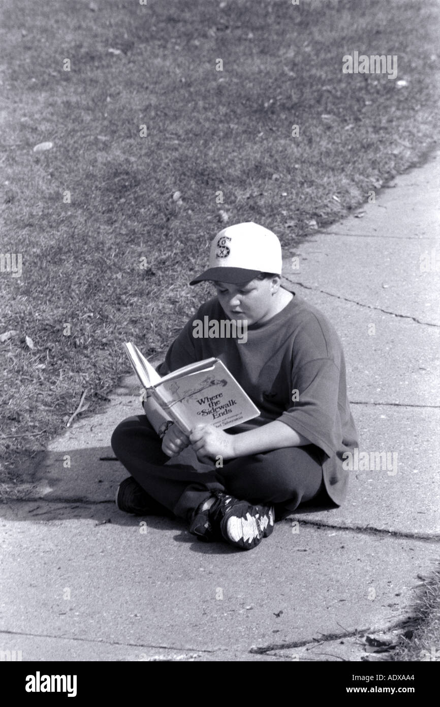 Boy Reading Outside Stock Photo - Alamy