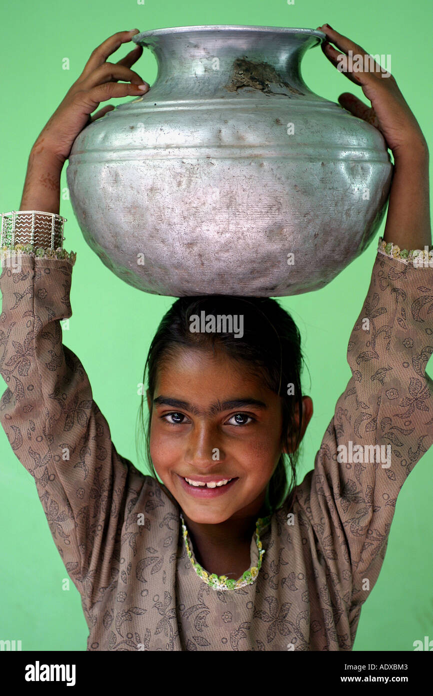 Girl carrying a pot of water coming from the well Saidpur Stock Photo ...