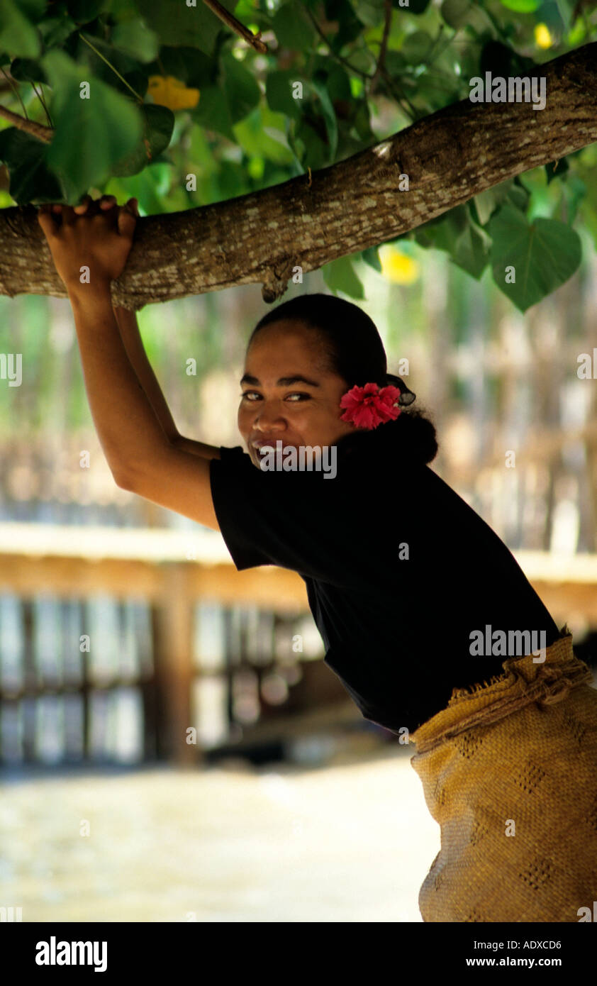 Smiling girl wears a traditional pandanus leave woven overskirt and ...