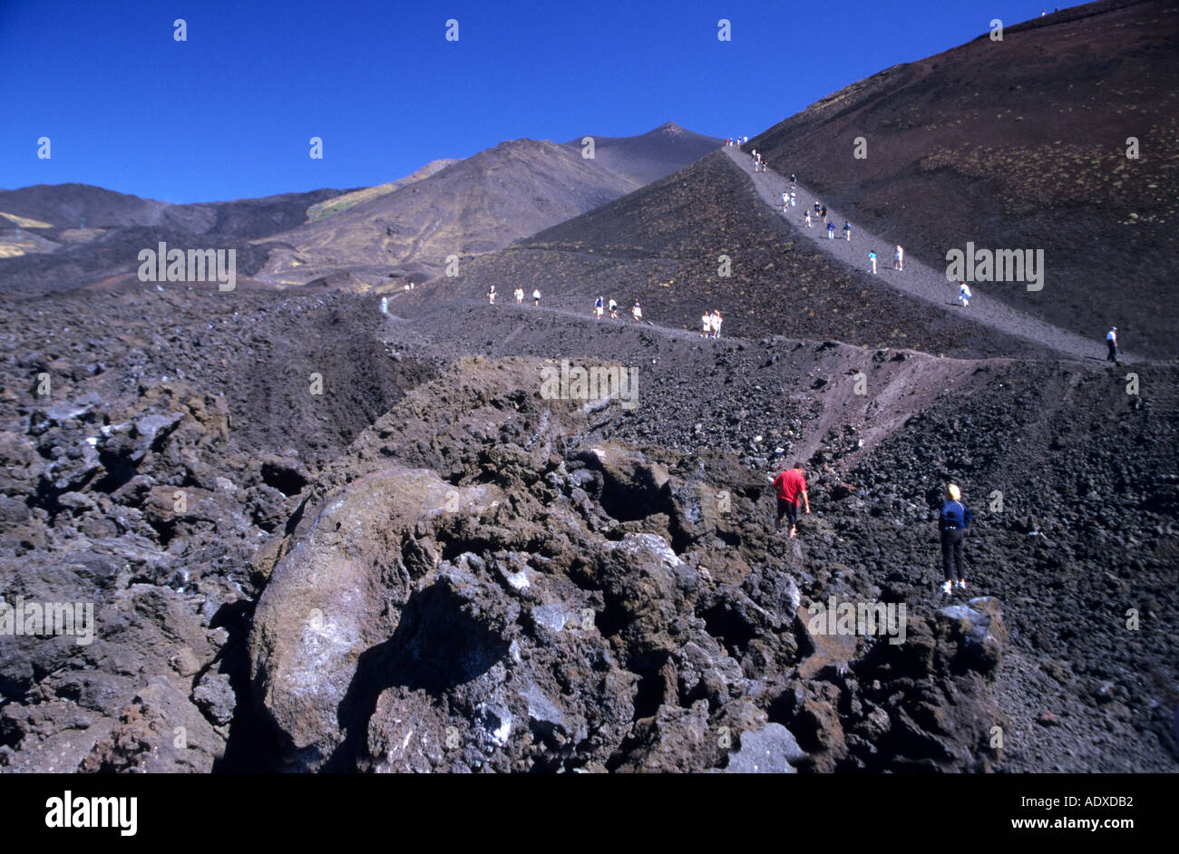 Tourist on the lava flow after the eruption of Mount Etna Sicily Italy ...