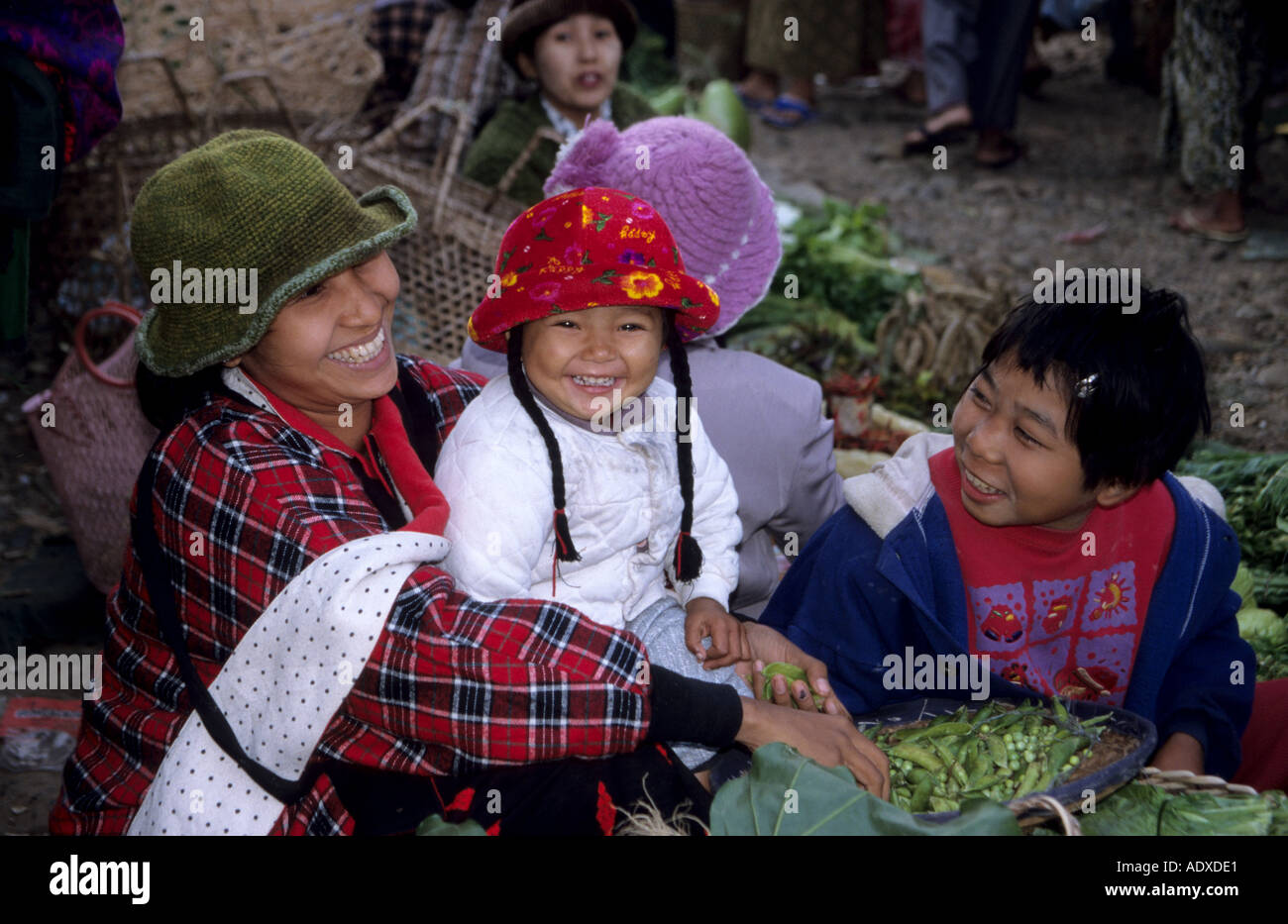 Happy family working in an early morning vegetable market Burma Myanmar ...