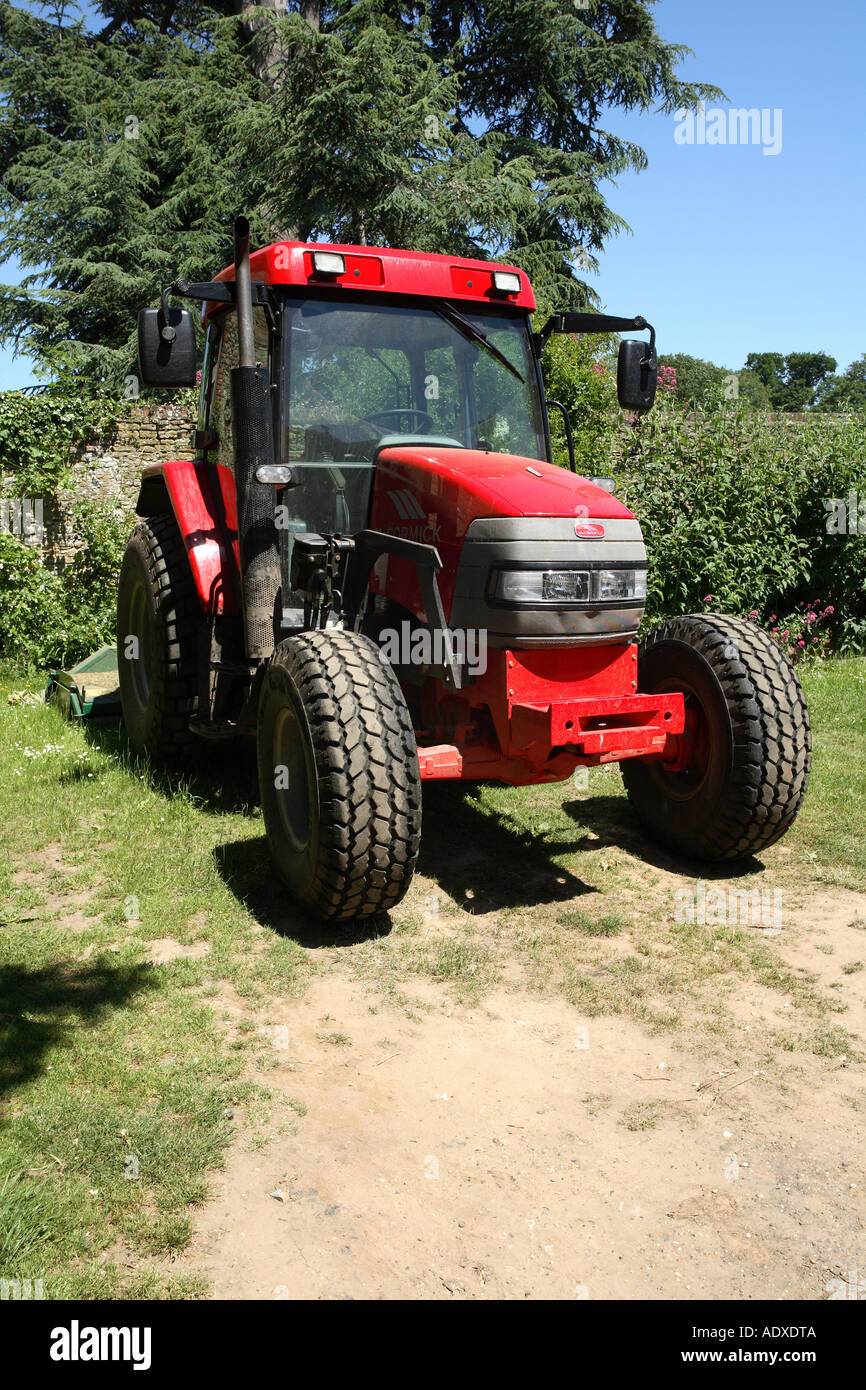 Red tractor on a dirt farm road. Surrey England Stock Photo - Alamy