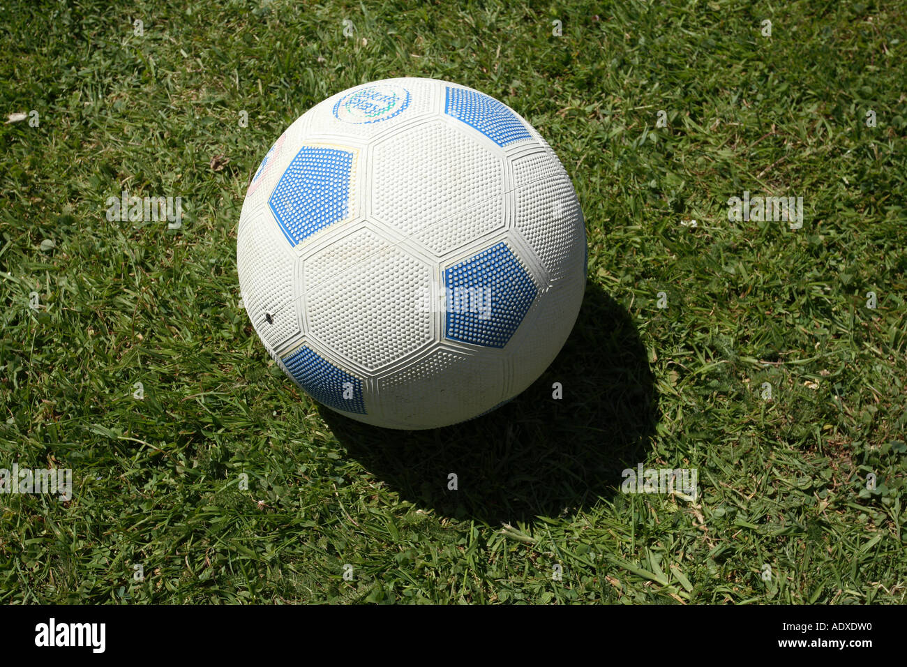 Rubber football on the grass Stock Photo - Alamy