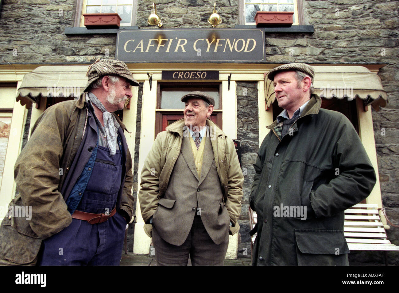 Three farmers talking outside a cafe in Bala Gwynedd North Wales UK ...