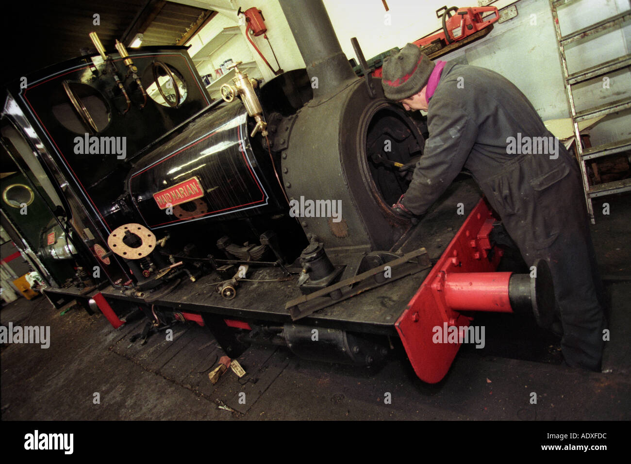 Engineer working on the boiler of a steam engine at Bala Lake Railway ...