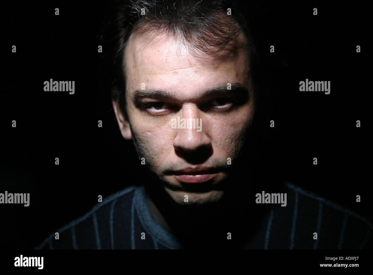 Headshot of defiant man Stock Photo - Alamy