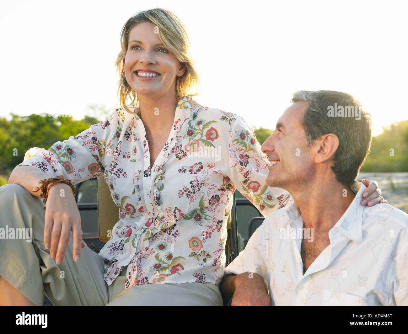 Portrait of couple outdoors, man looking at woman, smiling Stock Photo ...