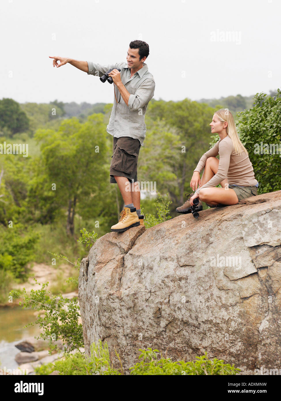 Man sitting on rock at the edge of river hi-res stock photography and ...