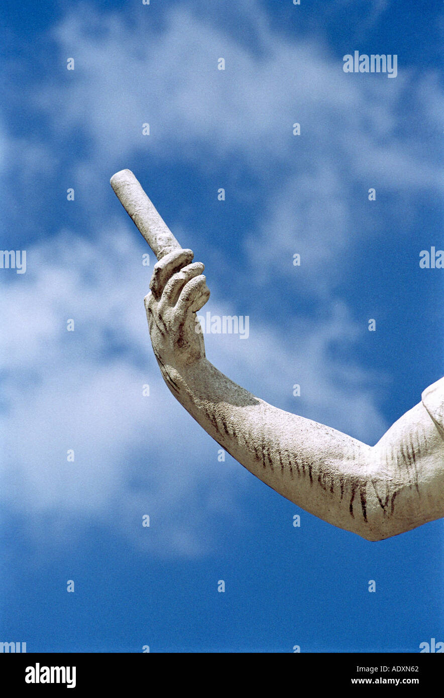 male statue s hand reaching out with baton and blue sky Stock Photo - Alamy