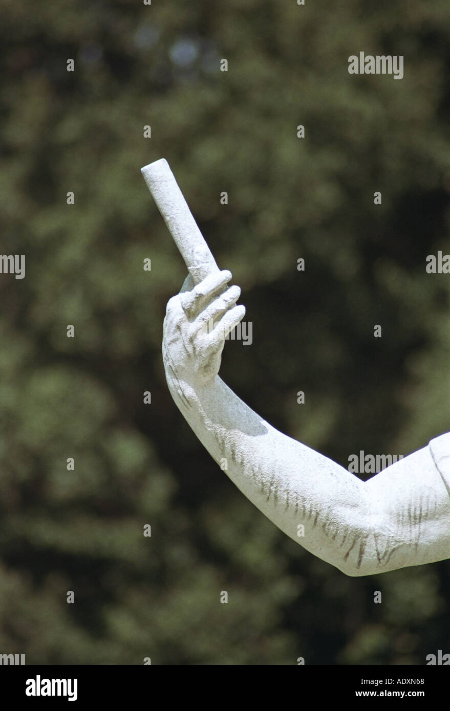 male statue s hand reaching out with baton and trees Stock Photo - Alamy