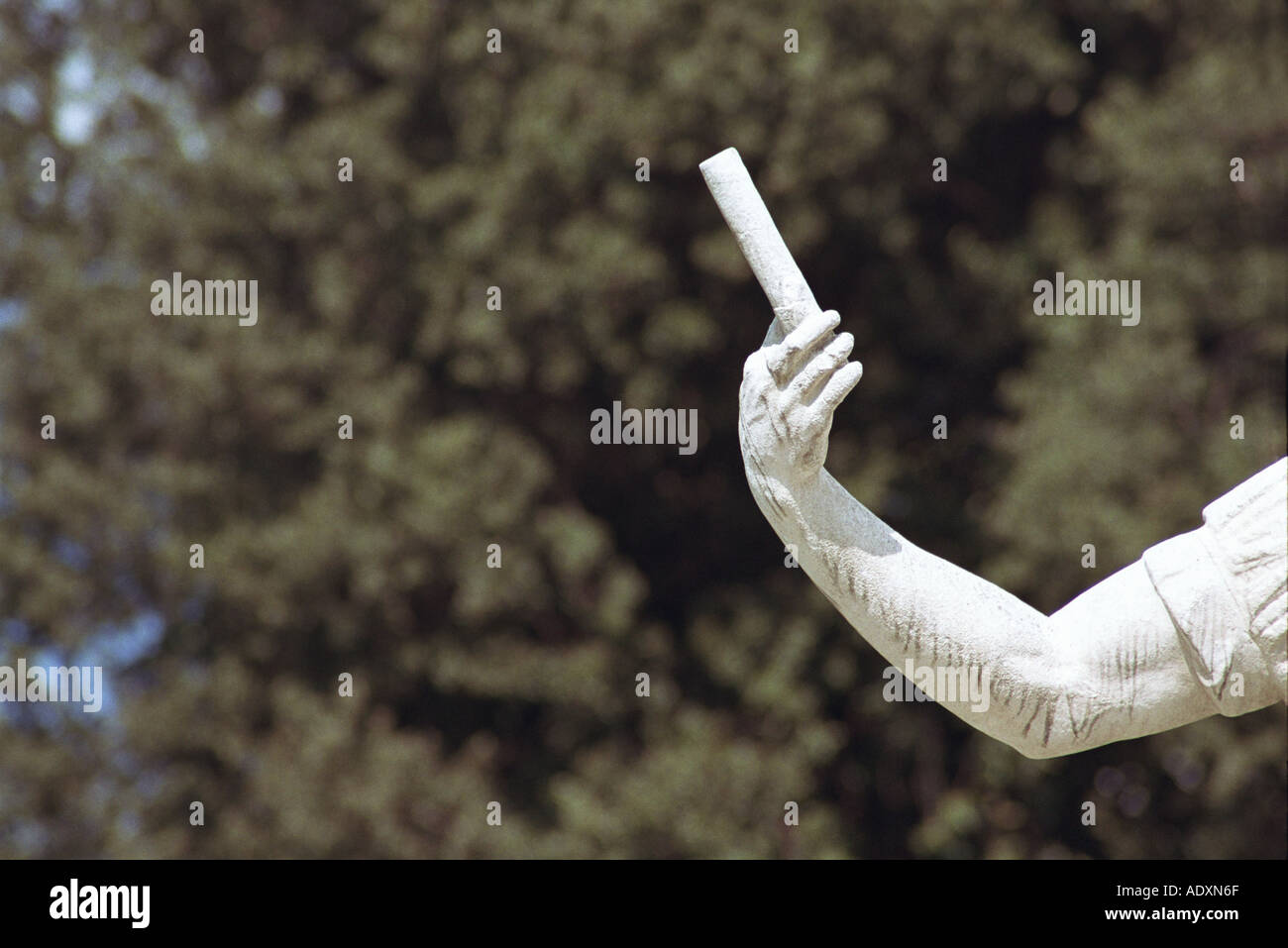 male statue s hand reaching out with baton and trees Stock Photo - Alamy