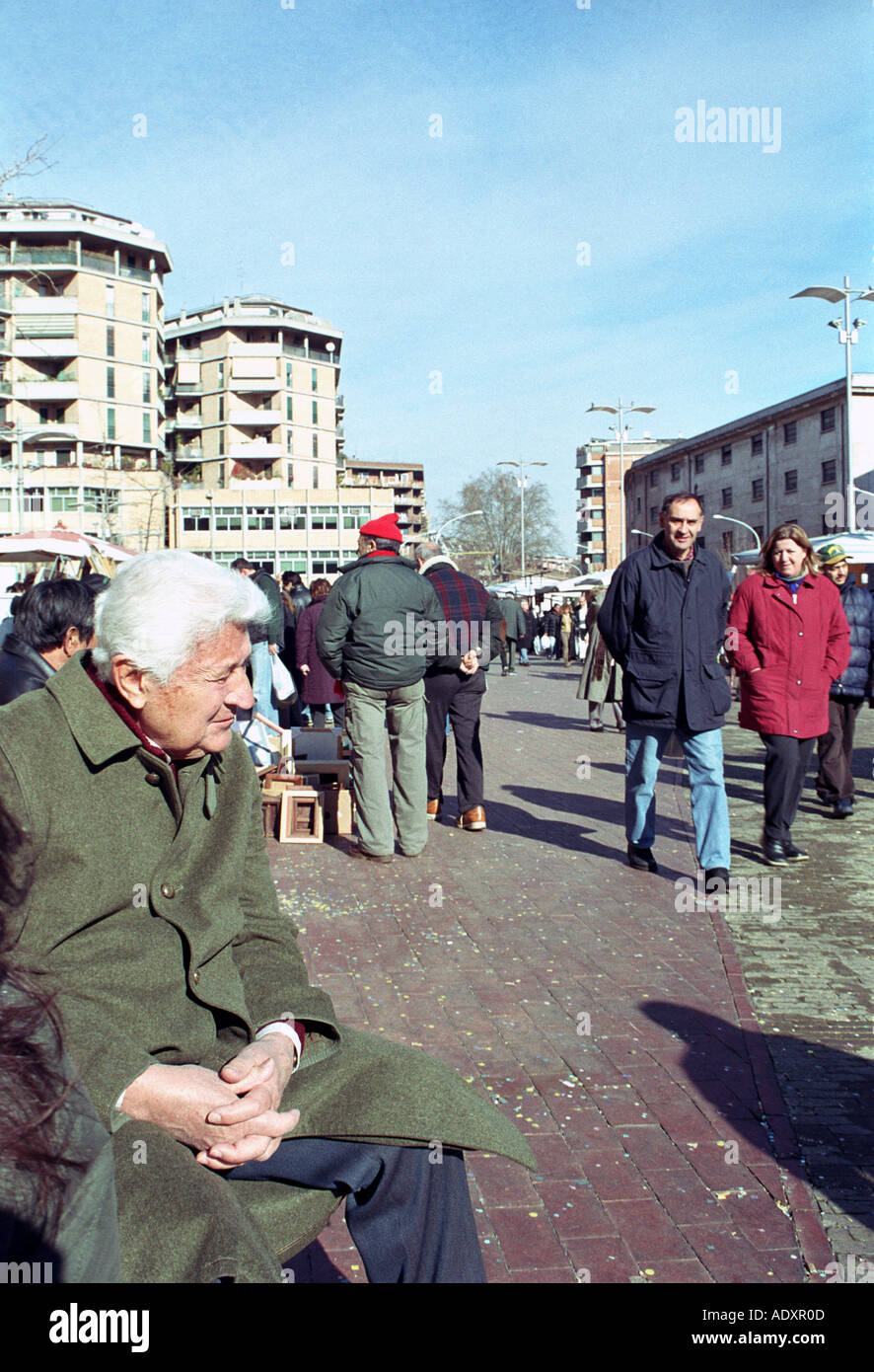 old man sitting down by busy street in rome in winter Stock Photo - Alamy