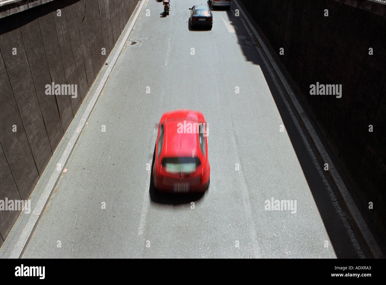 aerial view of red car moving on road movement Stock Photo - Alamy