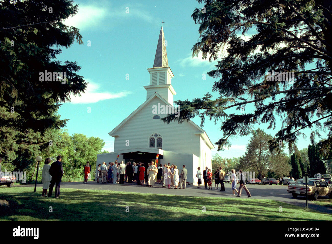 Priest greeting wedding guests entering Catholic Church. Excelsior ...