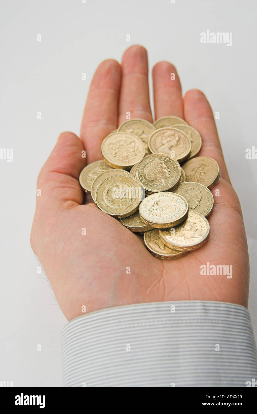 Hand pound coins hi-res stock photography and images - Alamy
