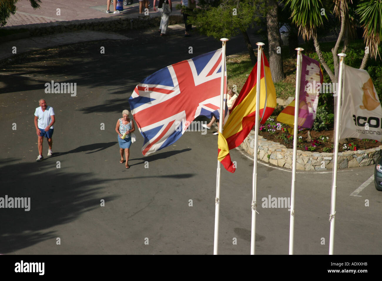 Flags on poles outside hotel in Palma Nova, Majorca Stock Photo - Alamy