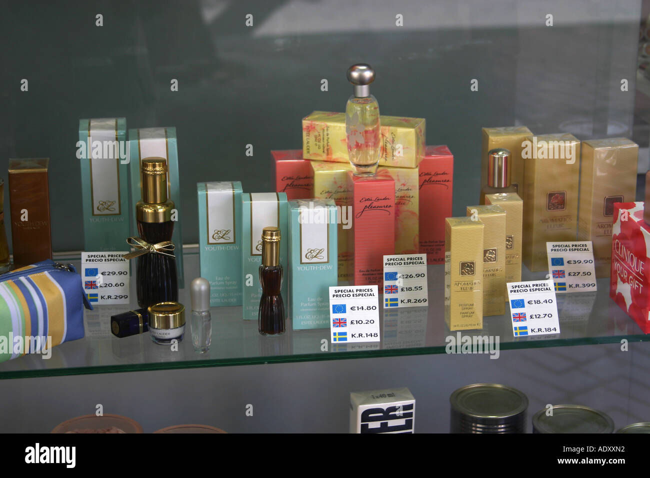 Selection of perfumes for sale on display in shop window Stock Photo ...