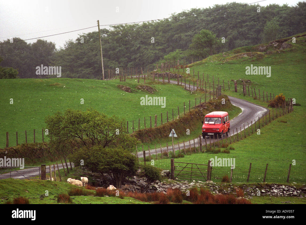 Post Bus driving through country lane in countryside near Aberystwyth ...