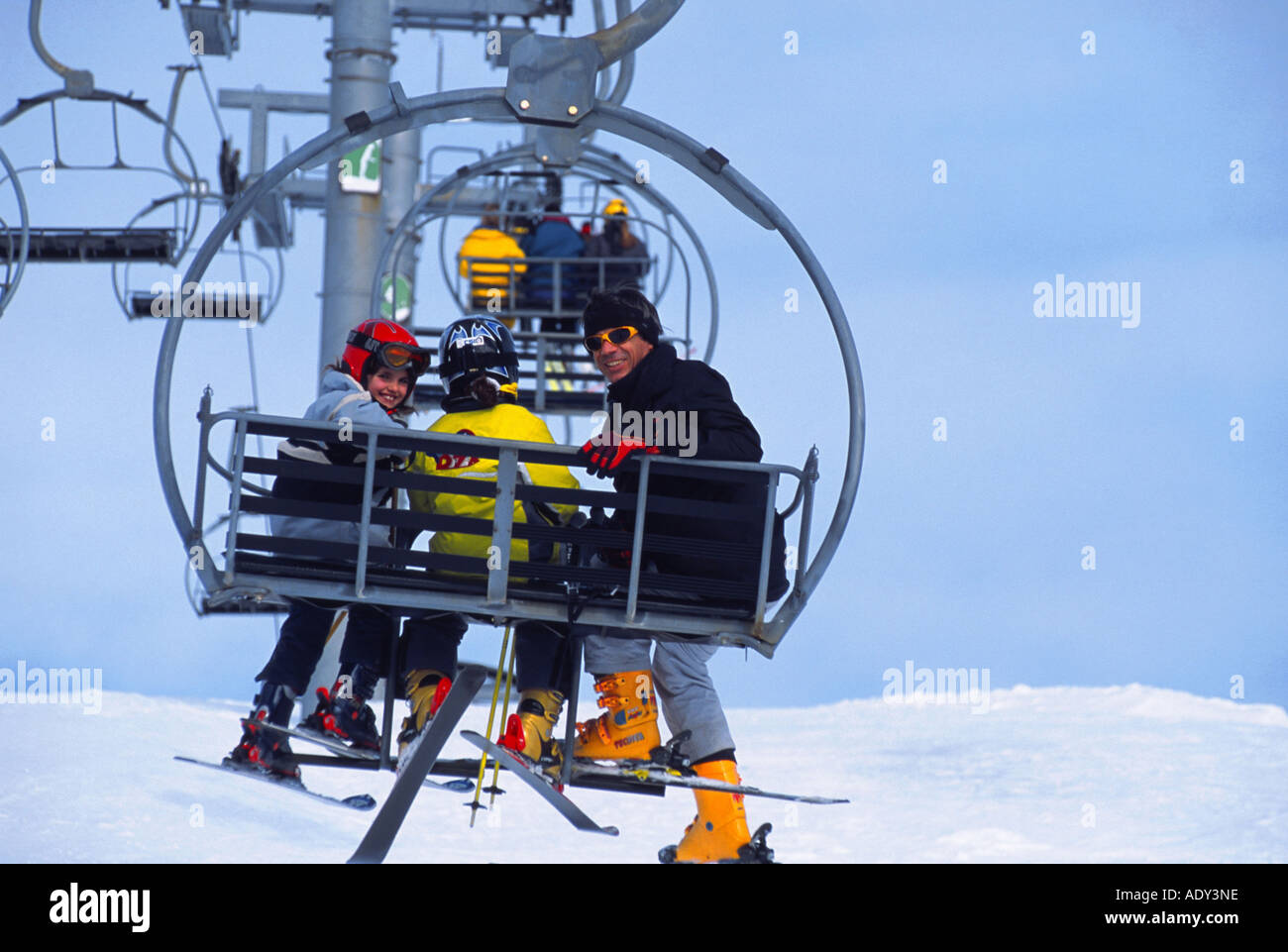 skier in chair lift, sitting side by side Stock Photo - Alamy